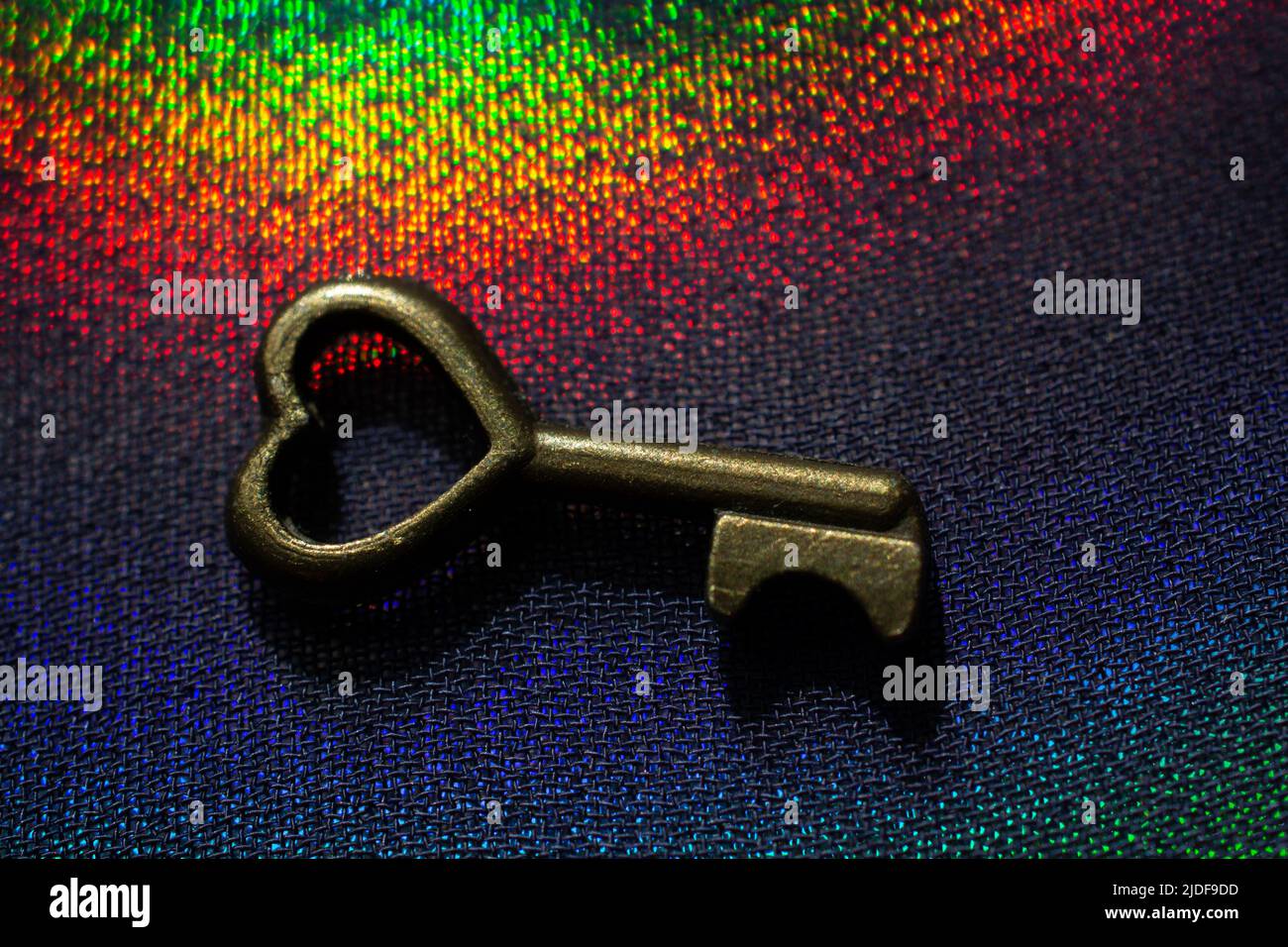 Vintage key. .Antique key. Retro key on colorful fabric background ...