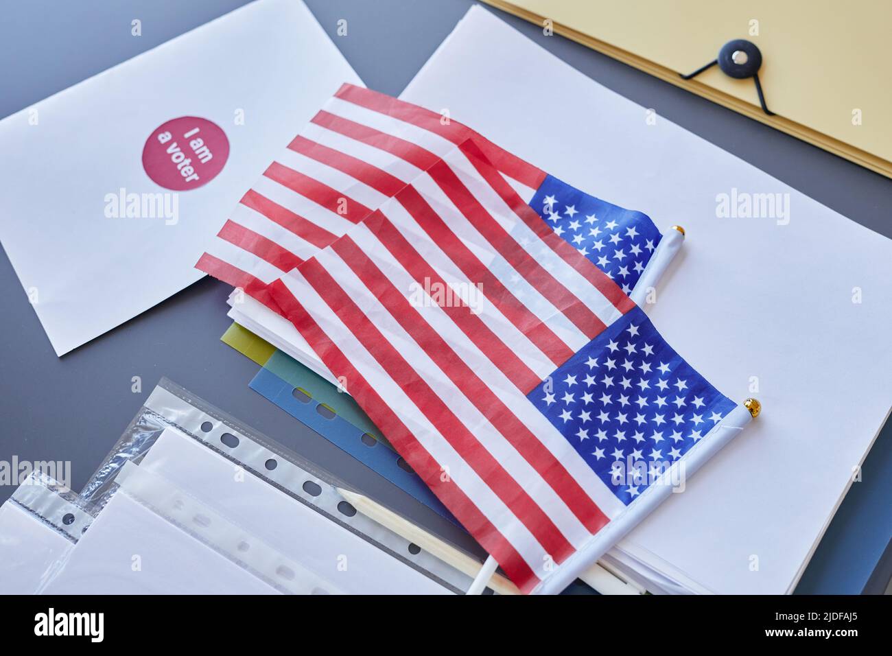 Background image of American flags with ballots on table in voting ...