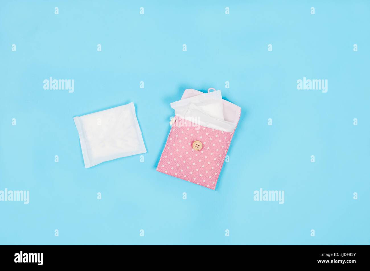 women's sanitary pads and pink handbag on a blue background. Hygienic ...