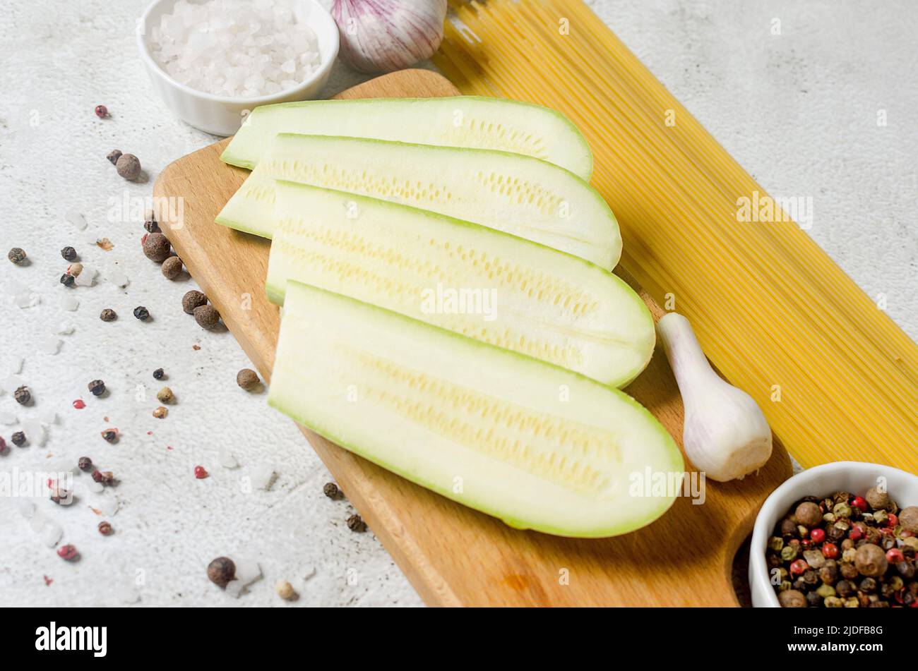 Raw long spaghetti with ingredients for cooking, marrow, tomatoes ...