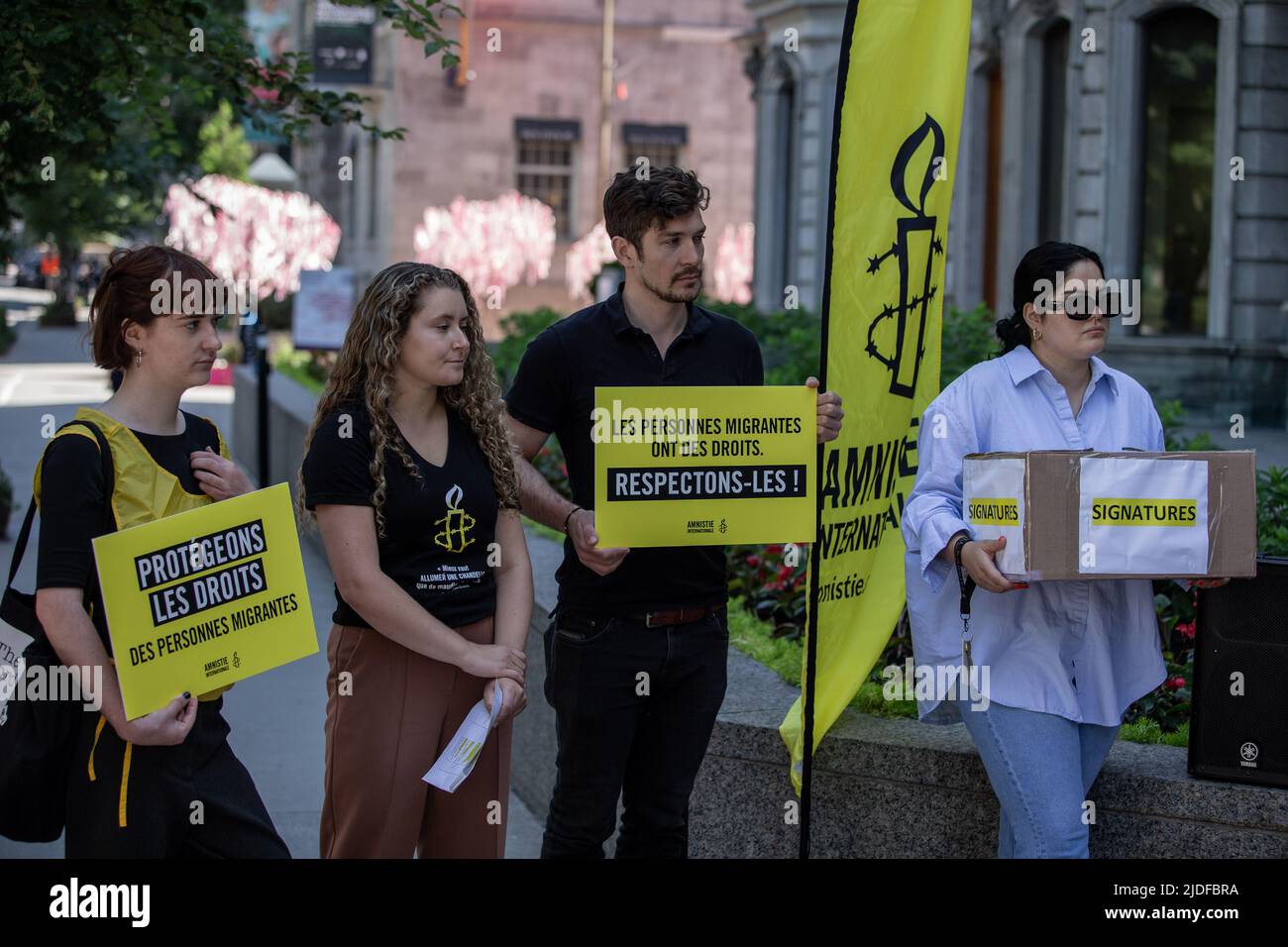 Amnesty International's staff hold placards supporting human rights ...