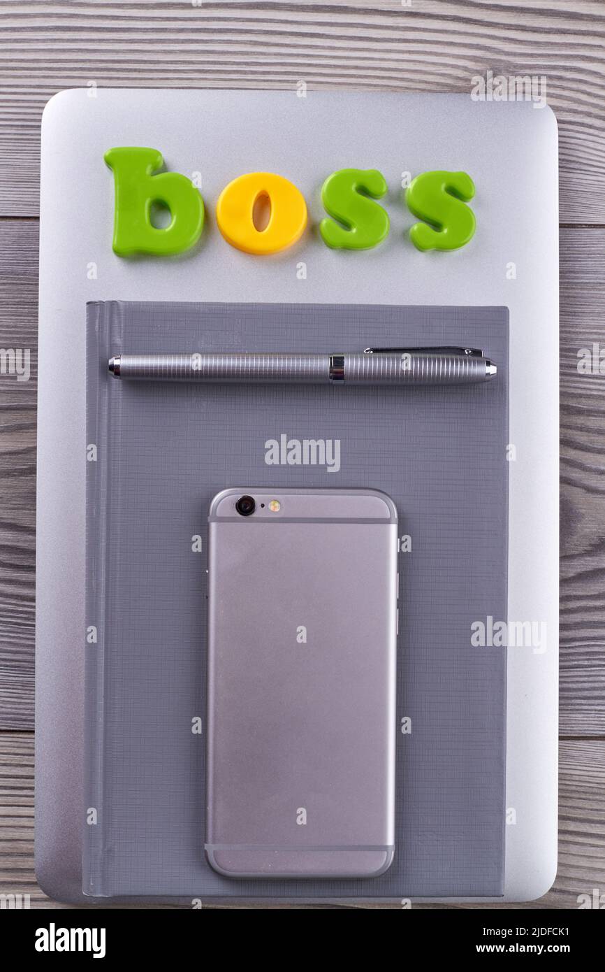 Vertical shot top view boss accessories concept. Laptop with notebook ...