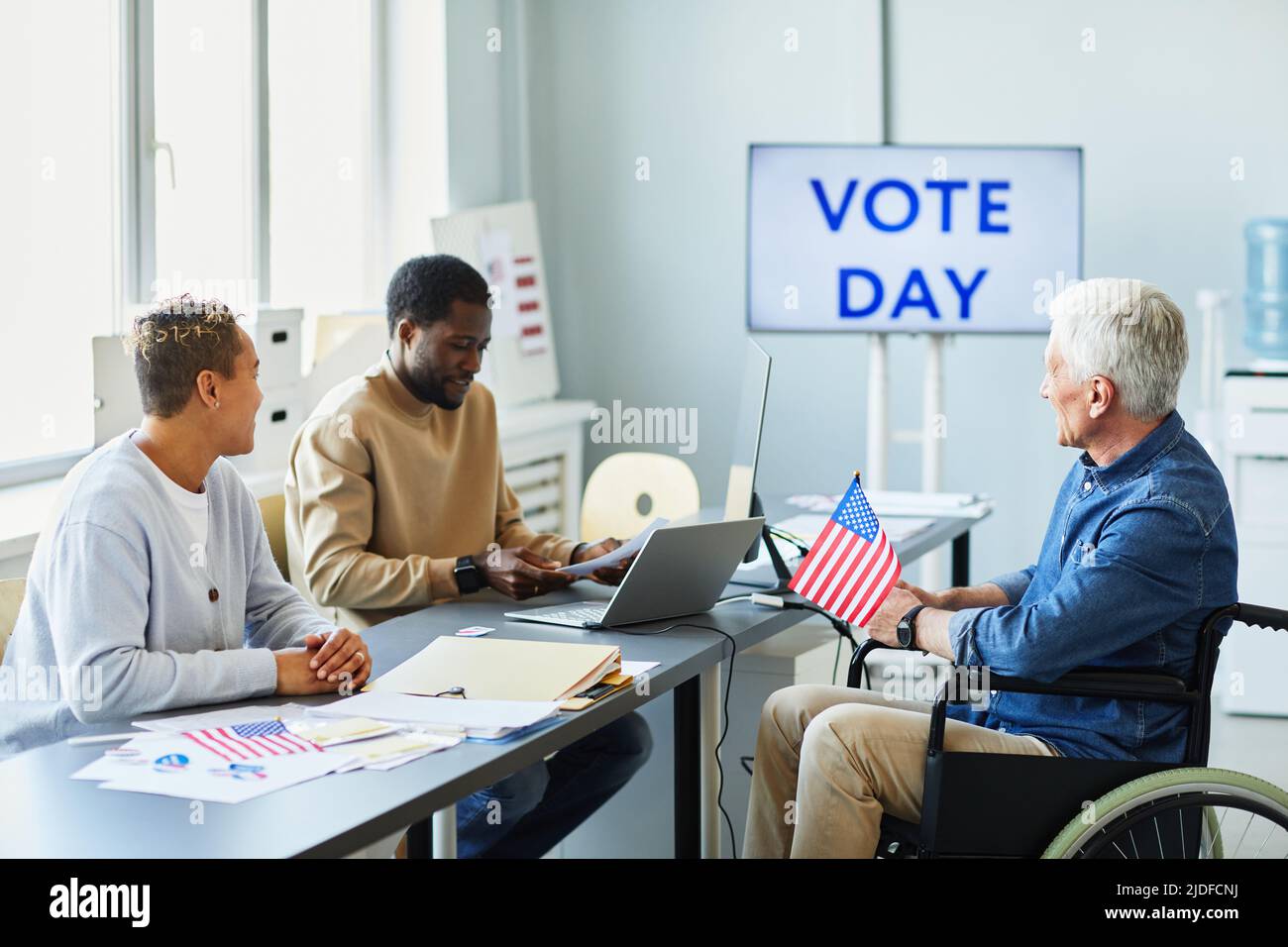 Side view portrait of senior man with disability at voting station on ...