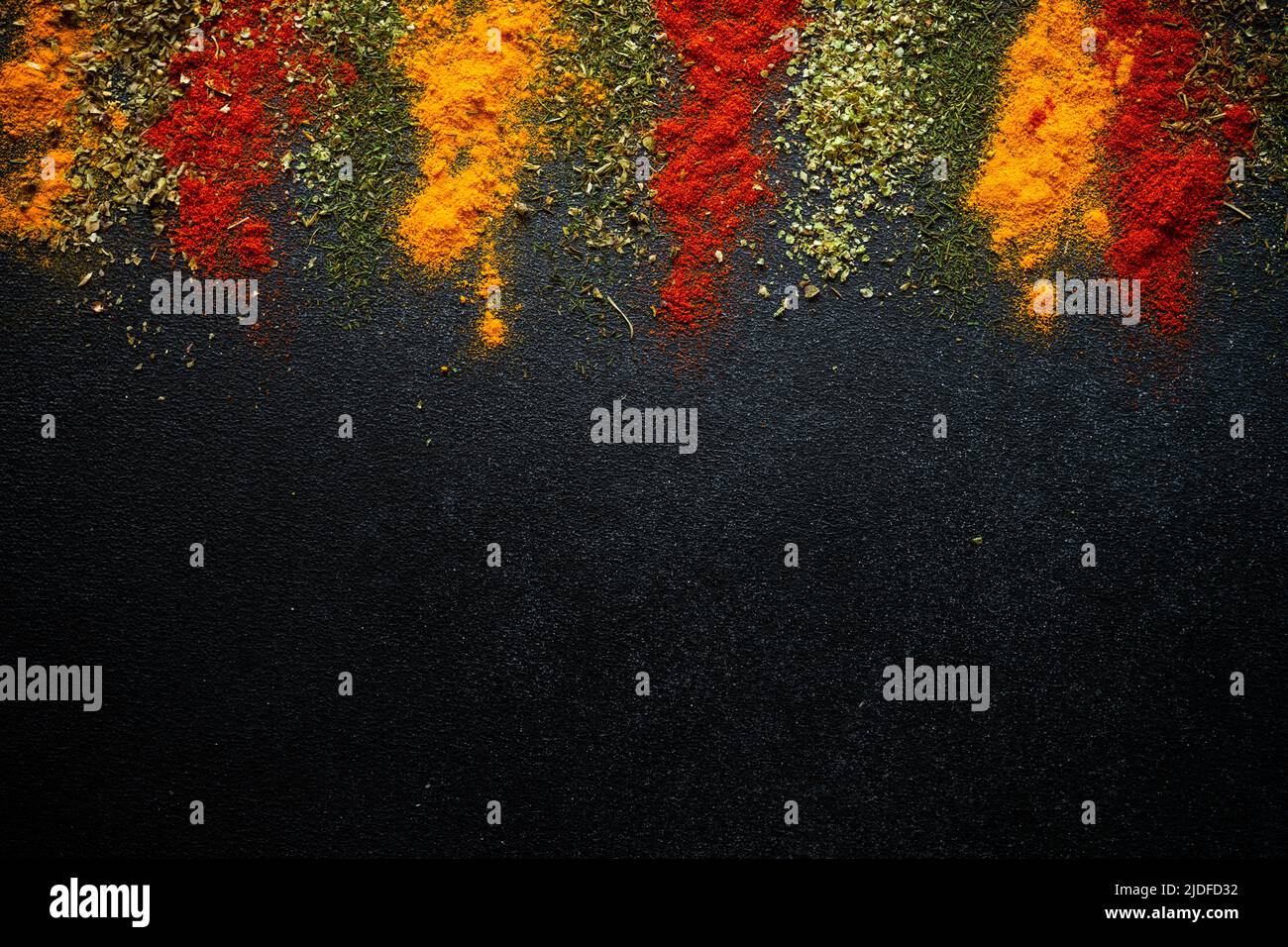 Spices powder on black slate background top view Stock Photo - Alamy