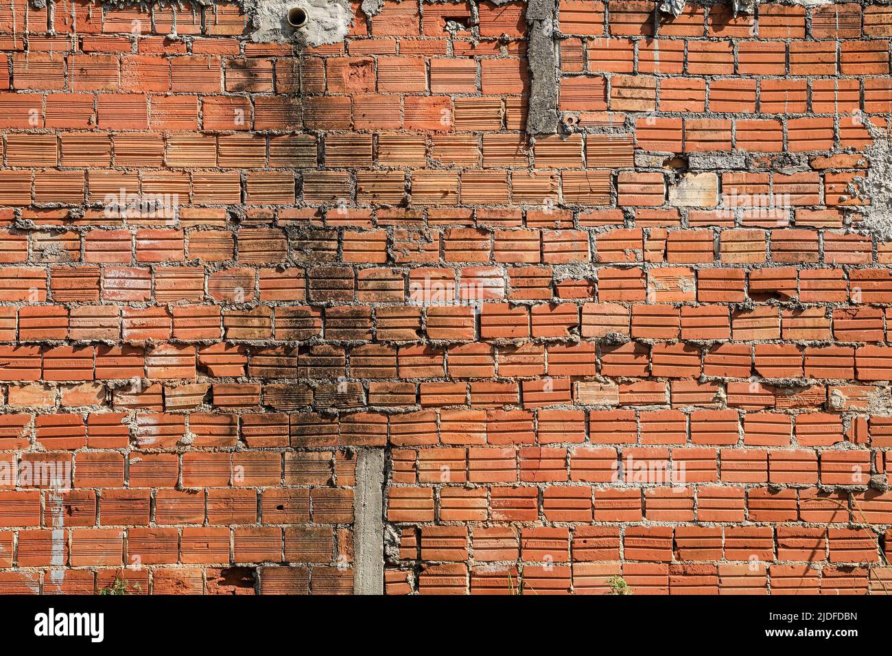 Wall mute with exposed brick, unfinished and with time marks ...