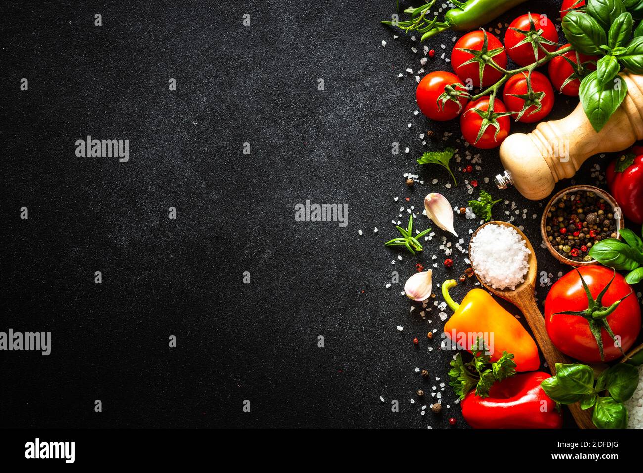Food cooking background on black stone table Stock Photo - Alamy