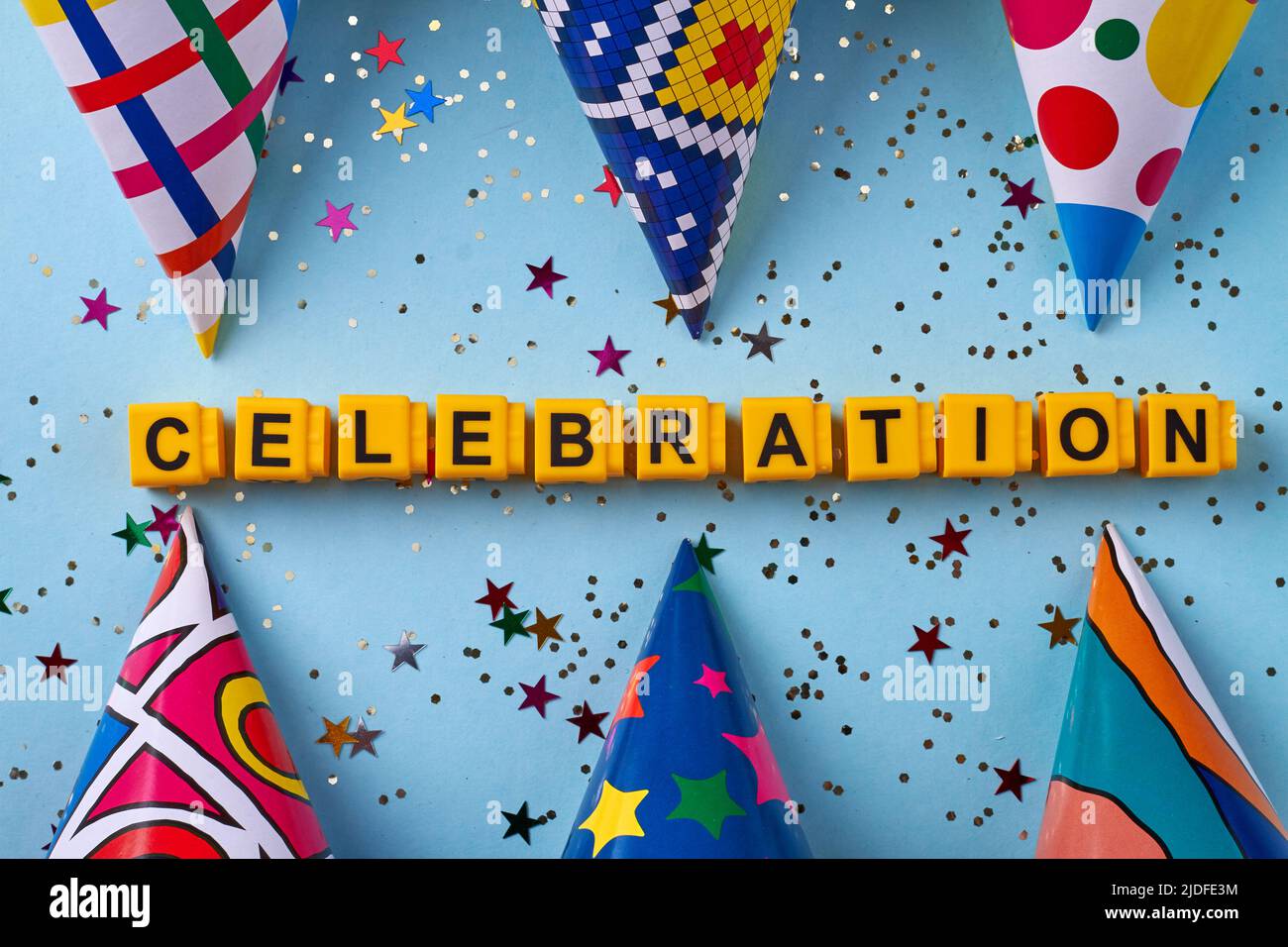 Flat lay celebration word and birthday cones with confetti. Isolated on ...