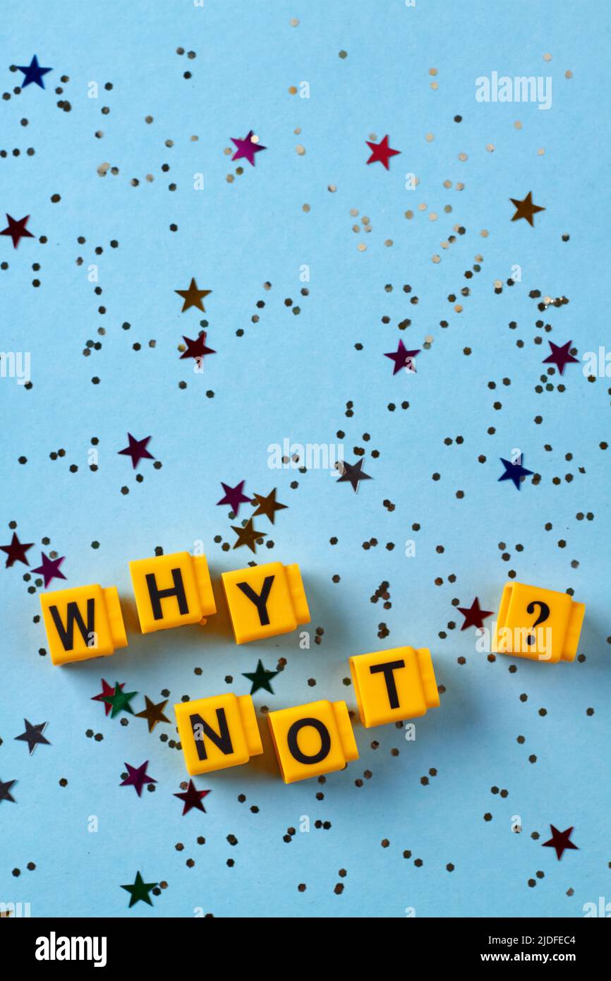 Vertical shot of yellow cubes with why not question inscription ...