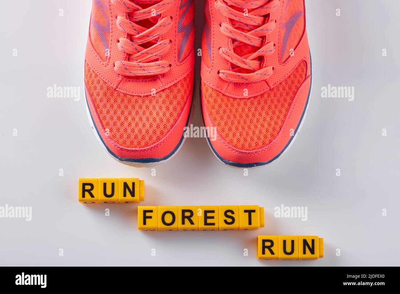 Pair of red sneakers with run forest run words. Isolated on white Stock ...
