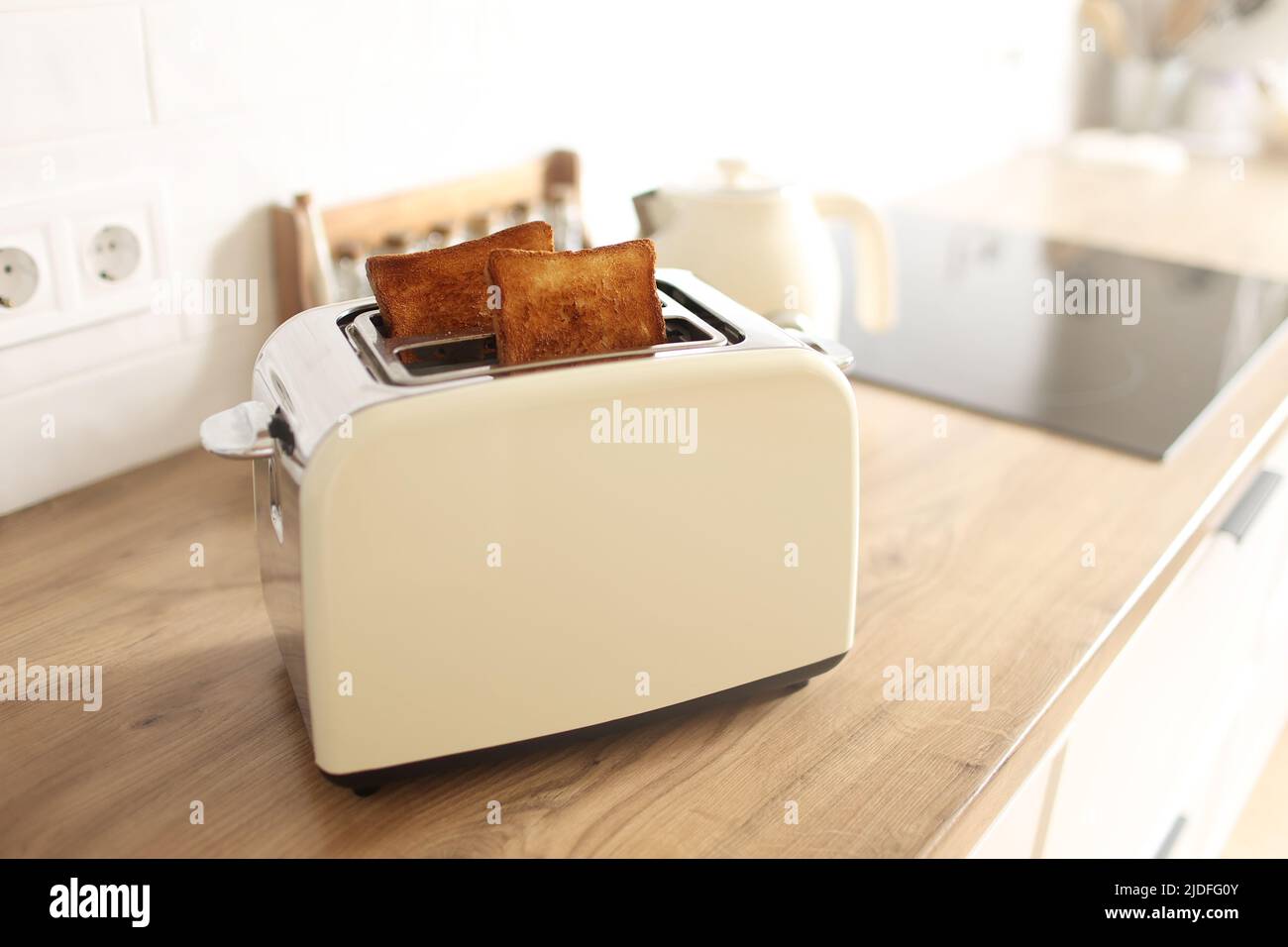 Toasted bread and toaster for breakfast. Modern white toaster and ...