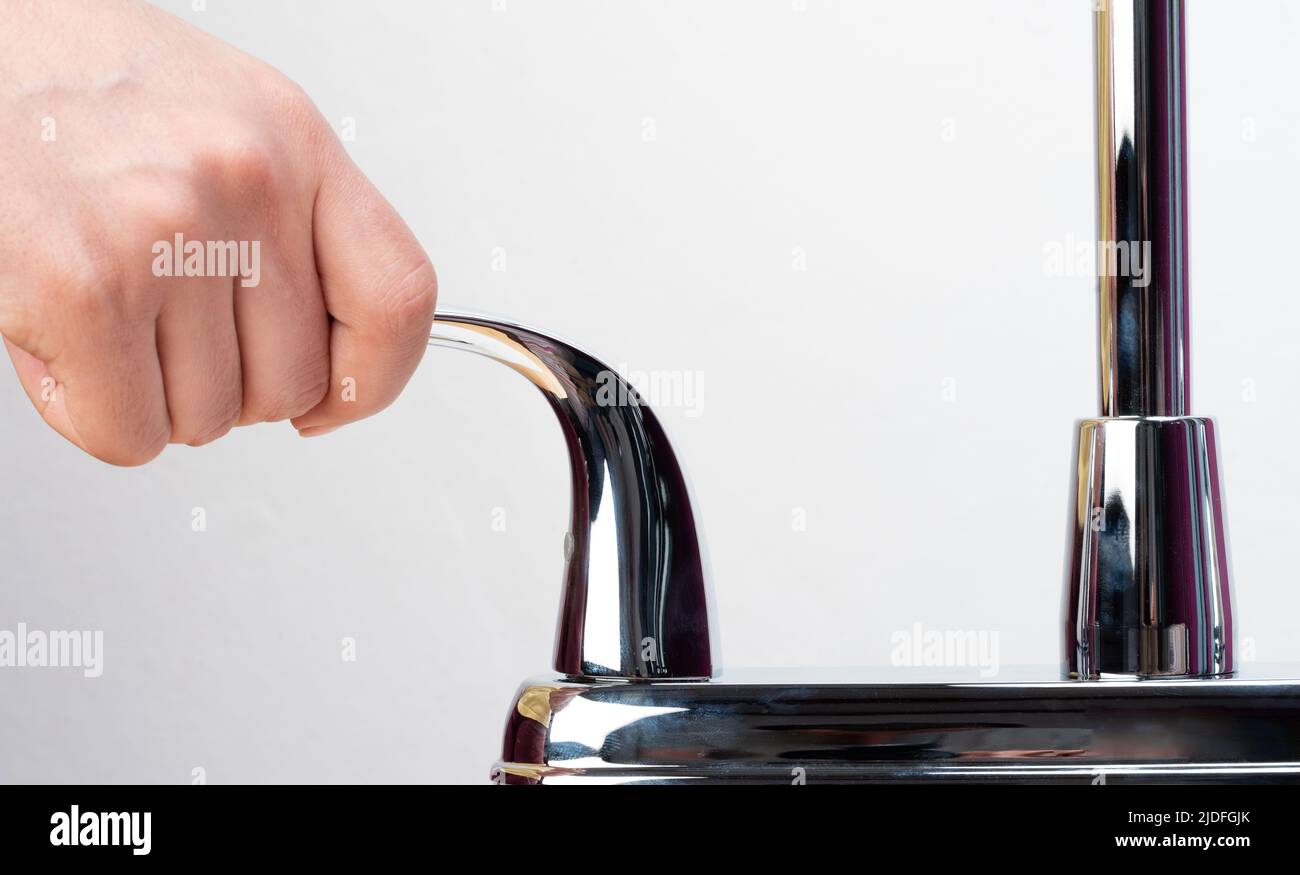 Hand hold handle and open water faucet isolated close up view Stock ...