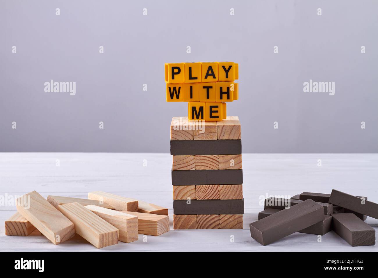 Stack of wooden blocks play with me letters. Tower building game jenga ...