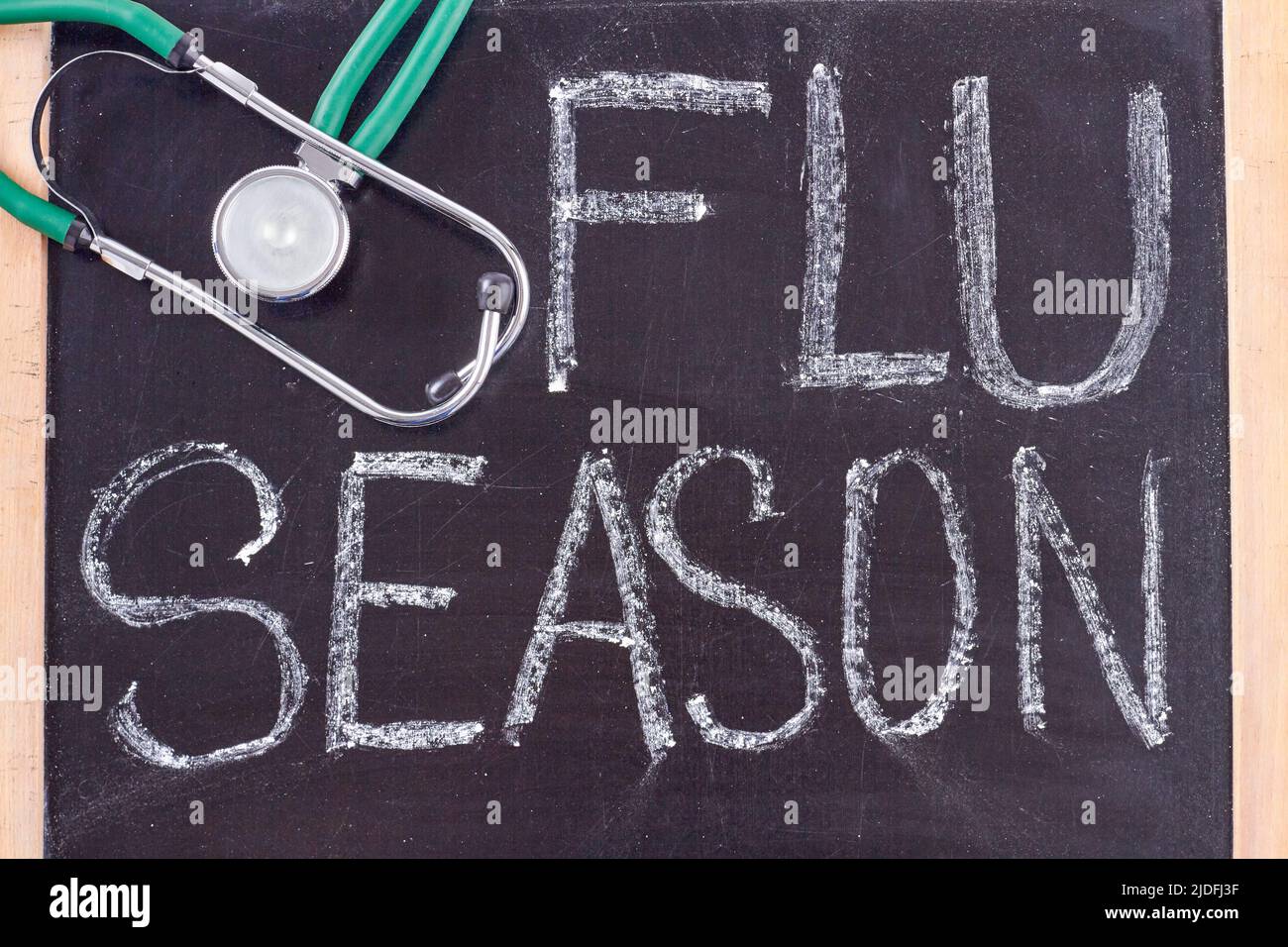 Blackboard with flu season handwriting and stethoscope. Chalkboard with ...