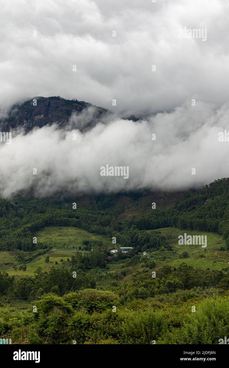 Beautiful roadside view of low moving cloud, greenery and mountainous ...