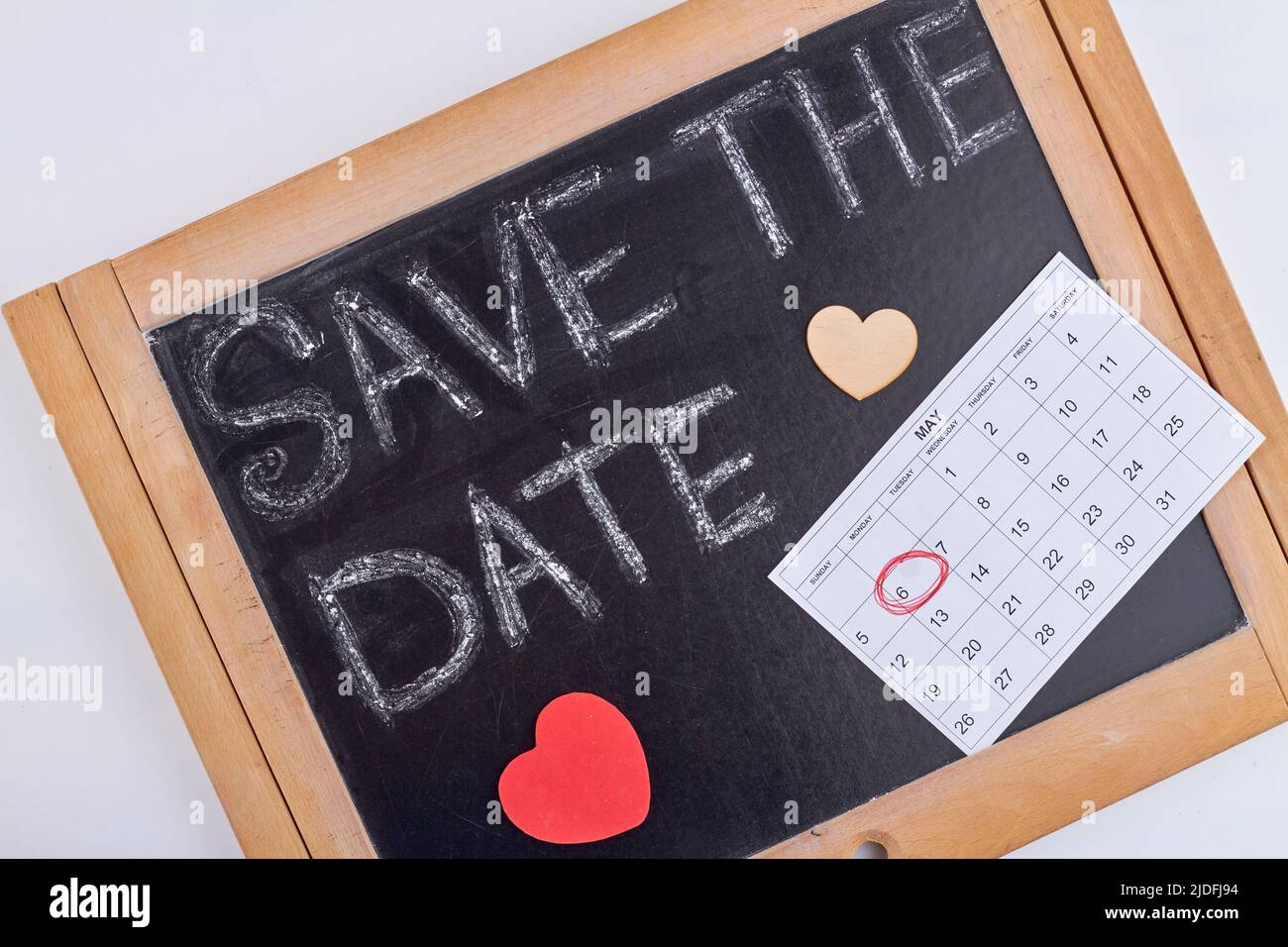 Save the date words written on blackboard. Calendar with with encircled ...