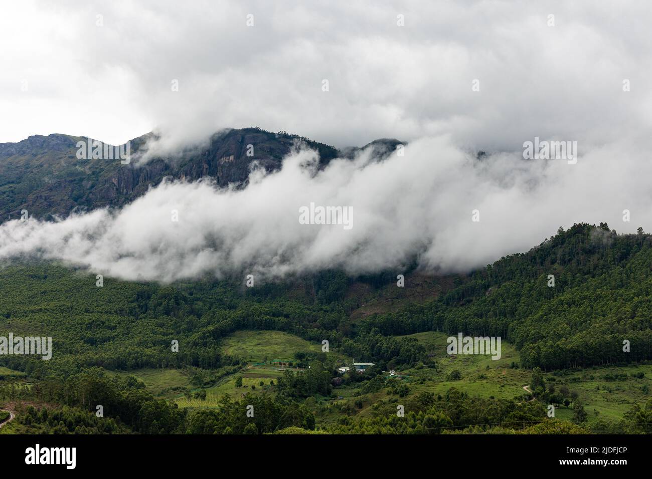 Beautiful roadside view of low moving cloud, greenery and mountainous ...