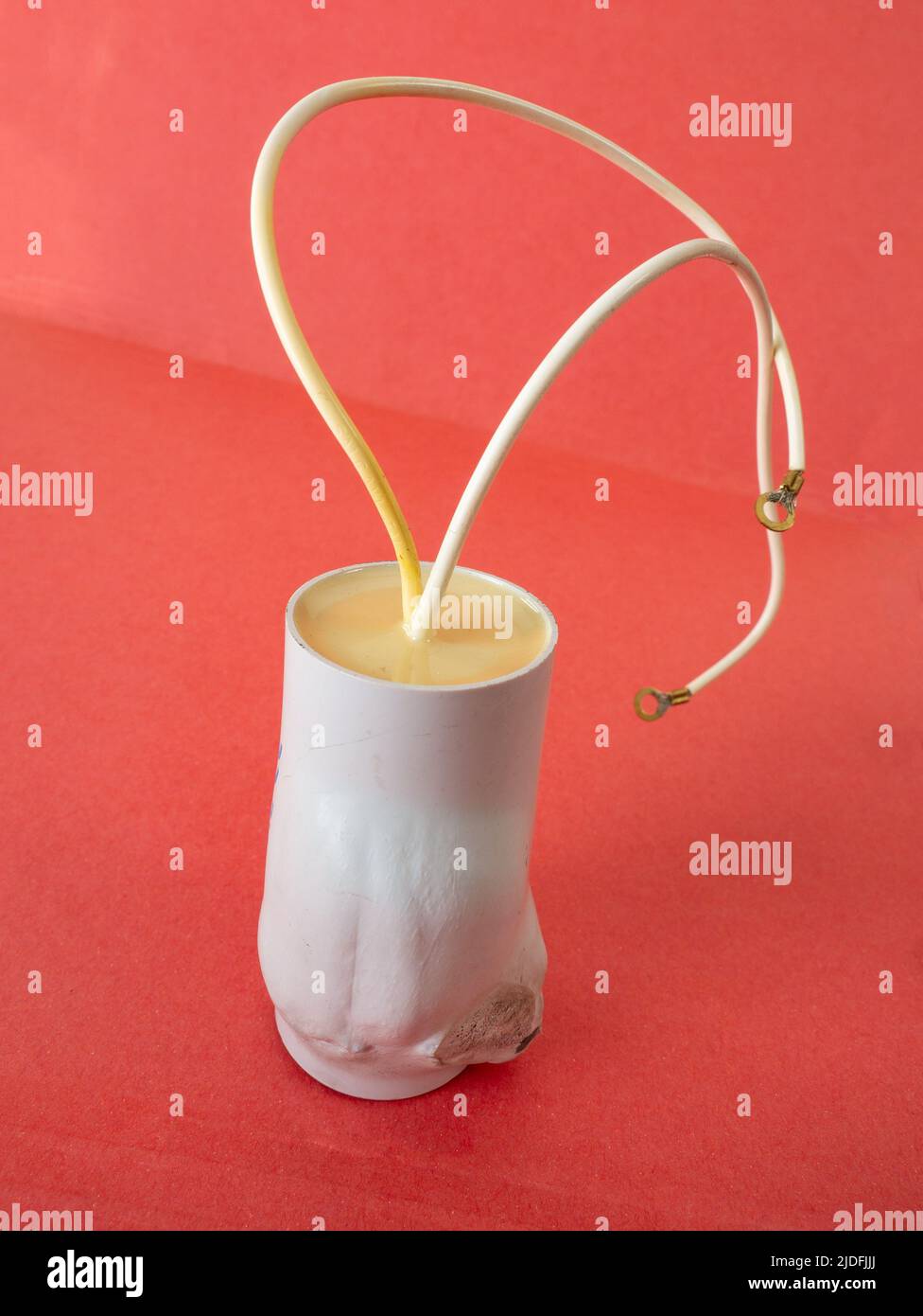 Swollen Electrolytic Capacitor (condenser or condensator) on red ...