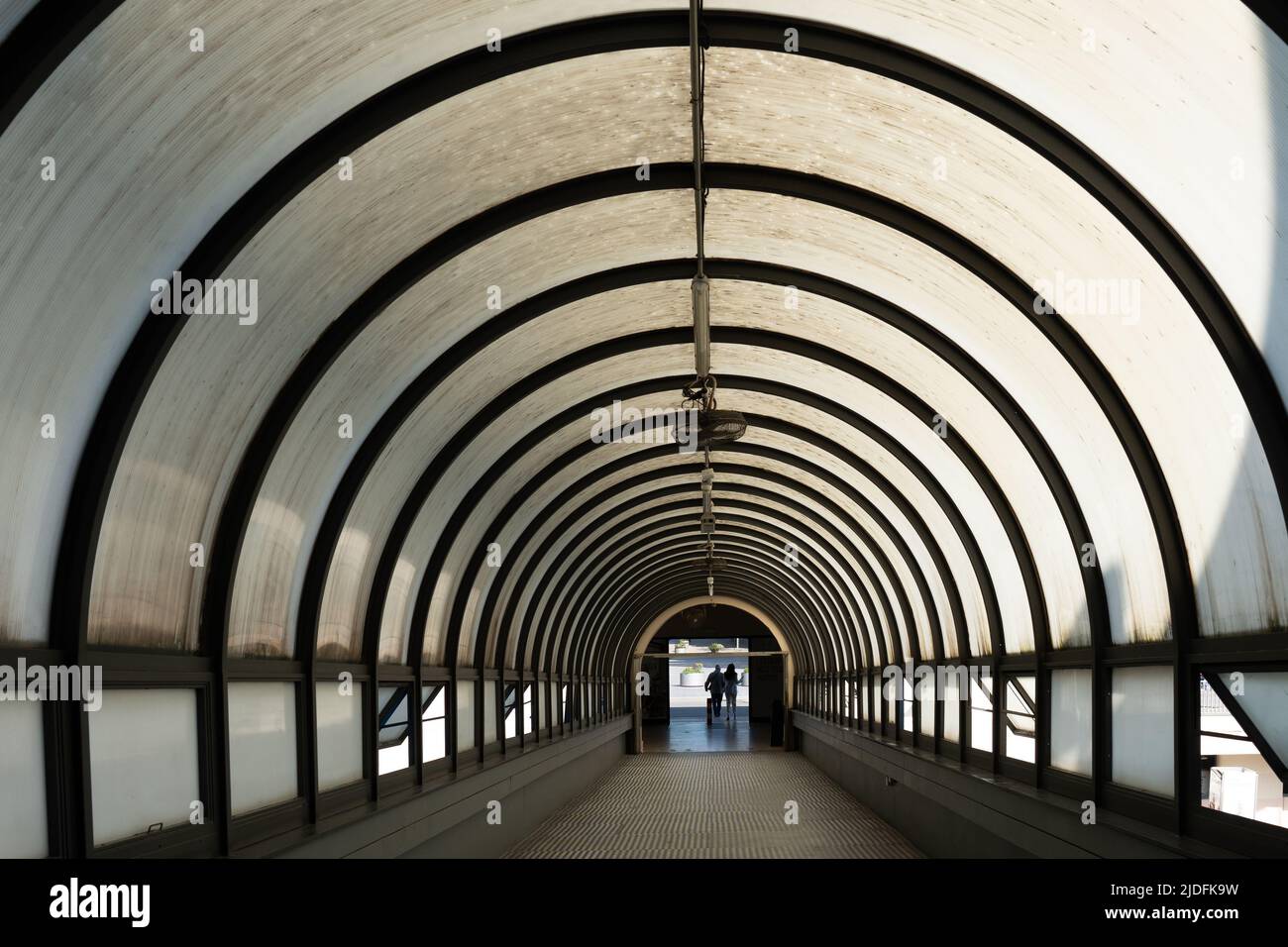 circular tunnel with pedestrians walking out. Inside of corridor for ...