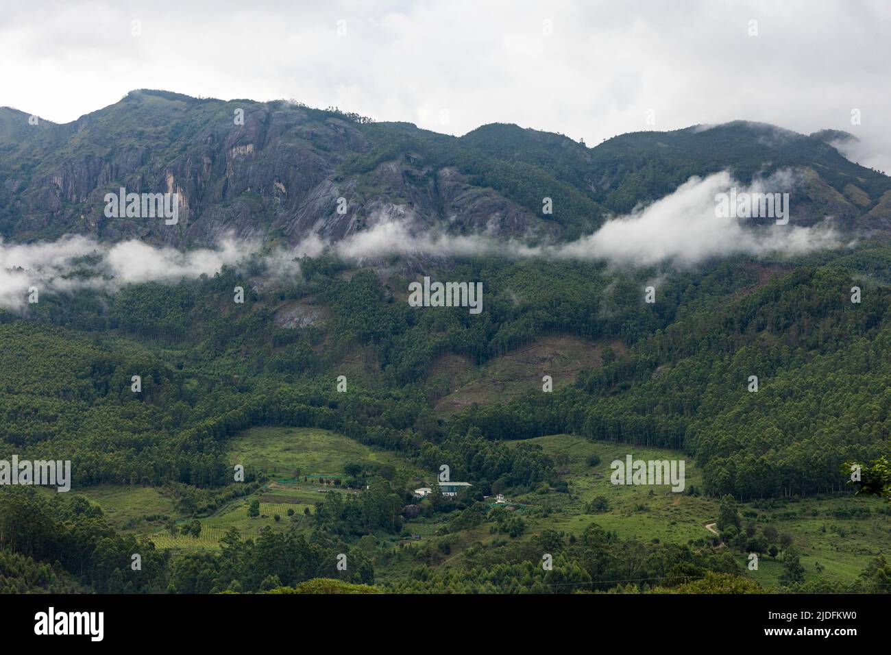 Beautiful roadside view of low moving cloud, greenery and mountainous ...