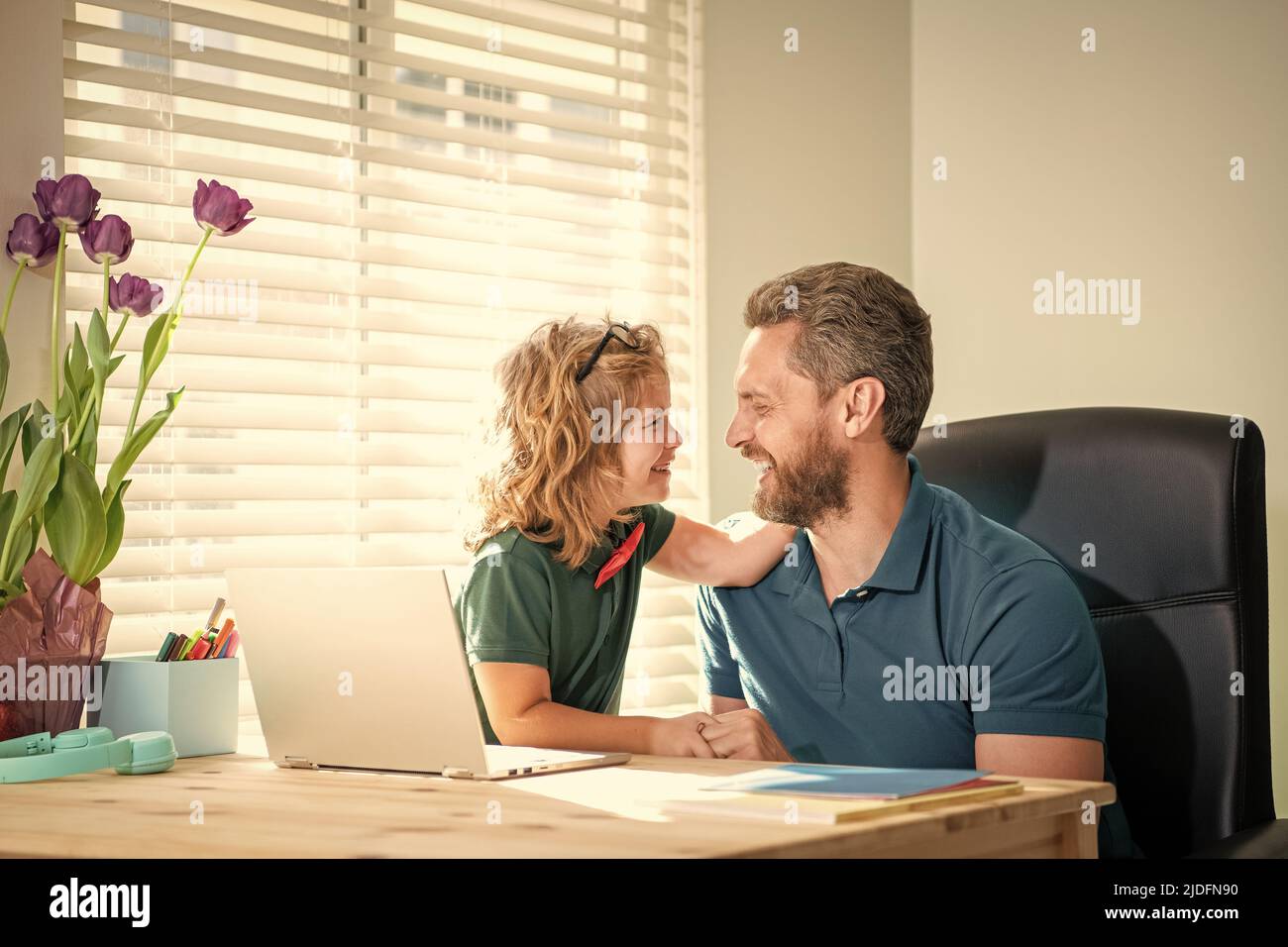 back to school. loving daddy and son in glasses use computer at home ...