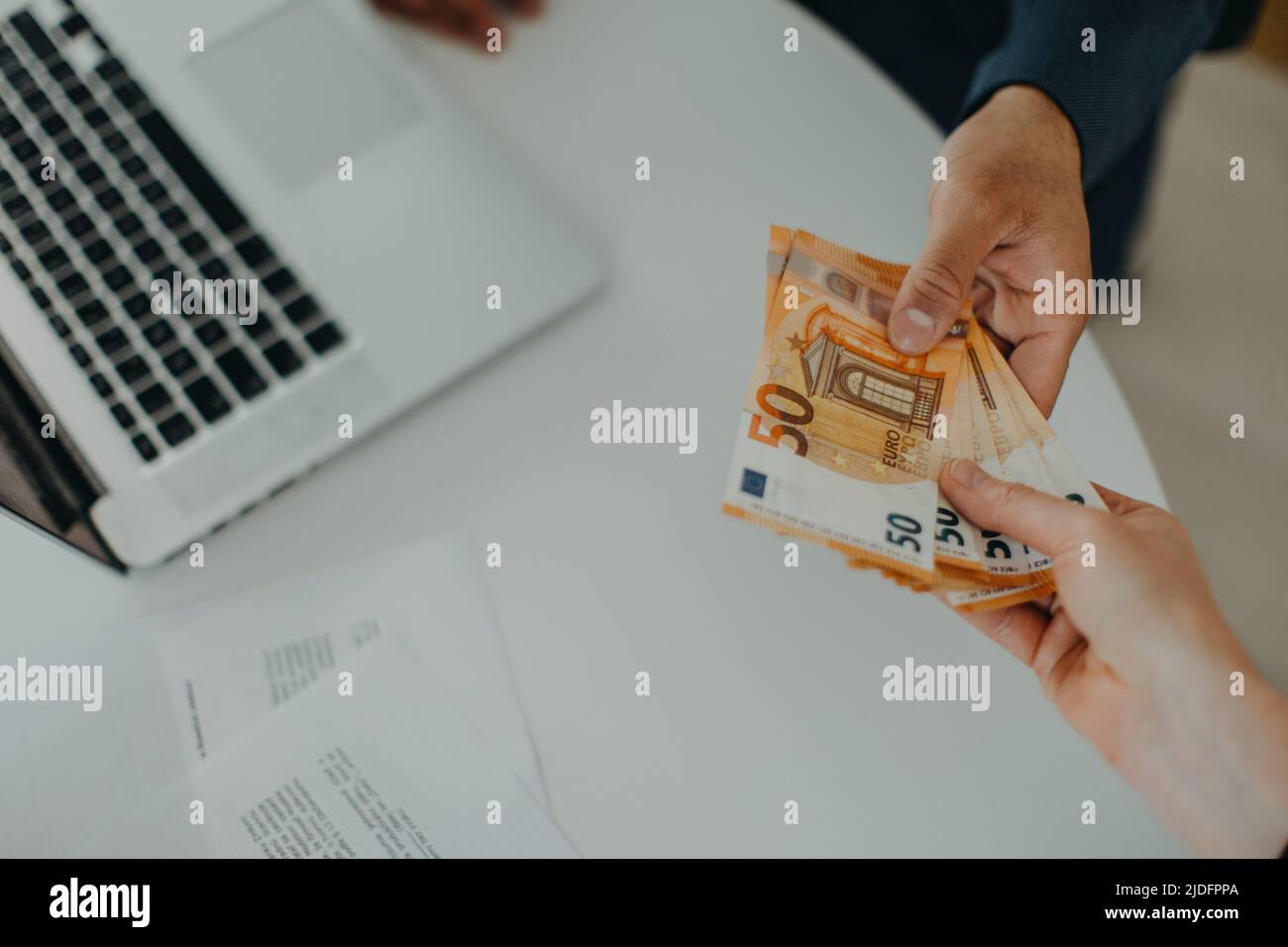 Businessman giving money to his partner while making contract - bribery ...