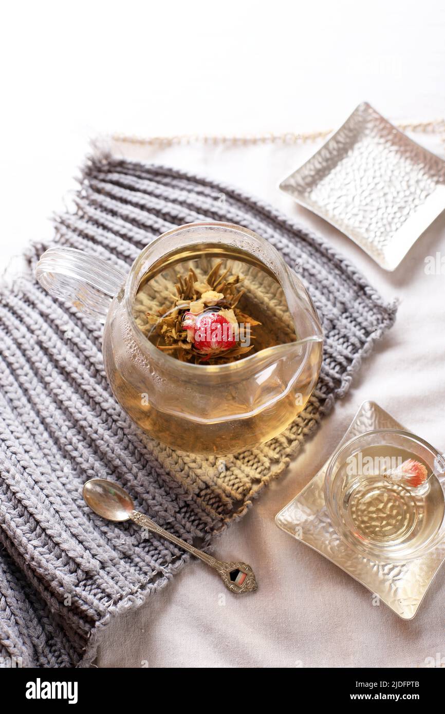 Exotic Green Tea Glass Teapot with Floral Blooming Tea Ball on White ...
