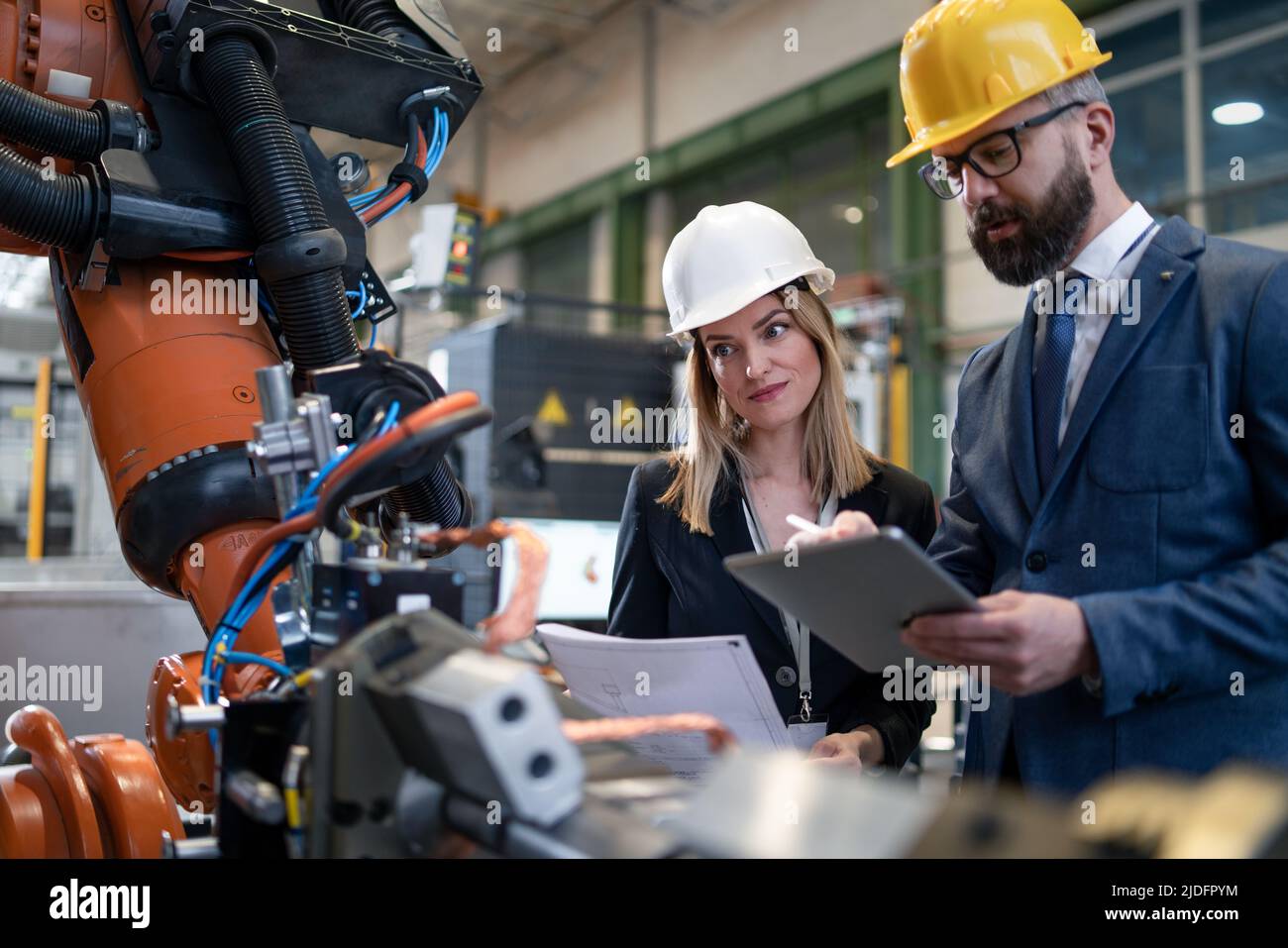 Chief engineer and project manager in modern industrial factory with ...