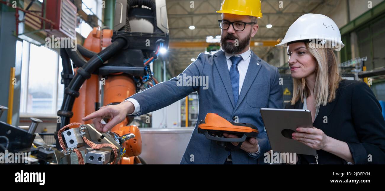 Chief engineer and project manager in modern industrial factory with ...