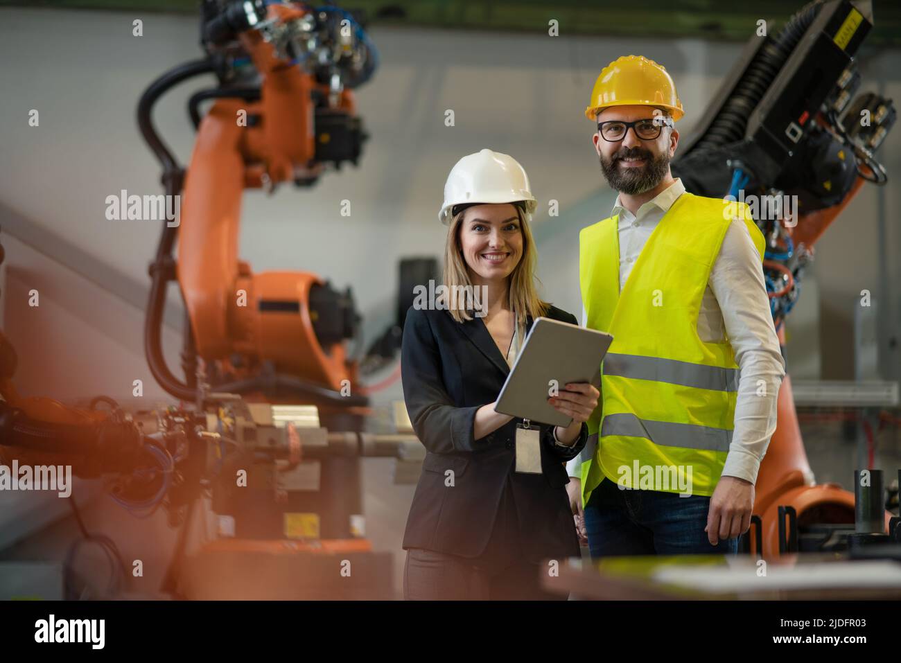 Chief engineer and project manager in modern industrial factory with ...