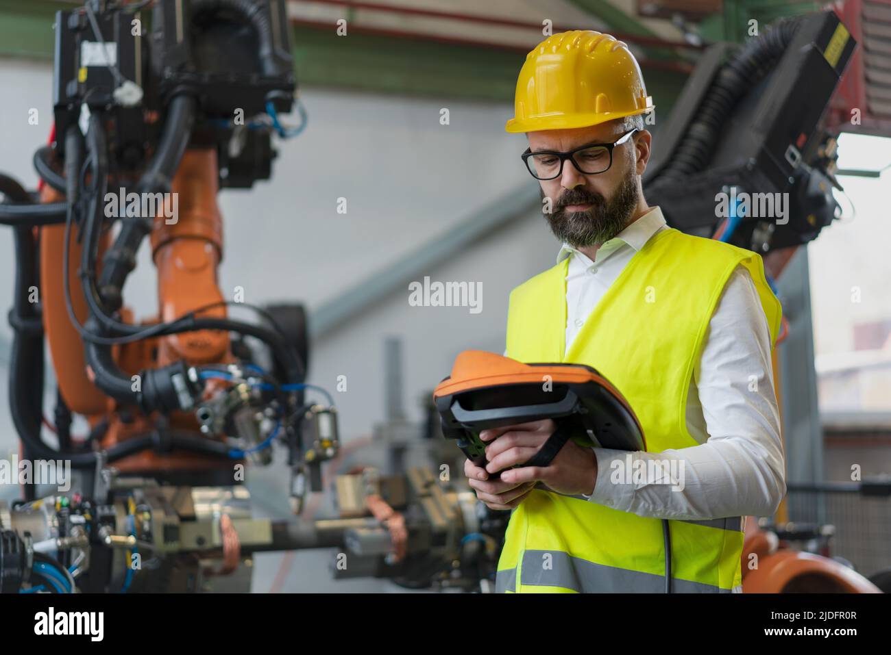 Automation engineer holding scanner in industrial in factory Stock ...