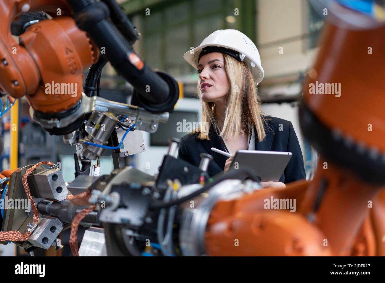 Female chief engineer in modern industrial factory using tablet and making audit Stock Photo - Alamy