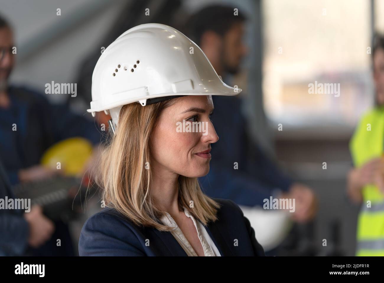Side view of a female chief engineer in modern industrial factory ...