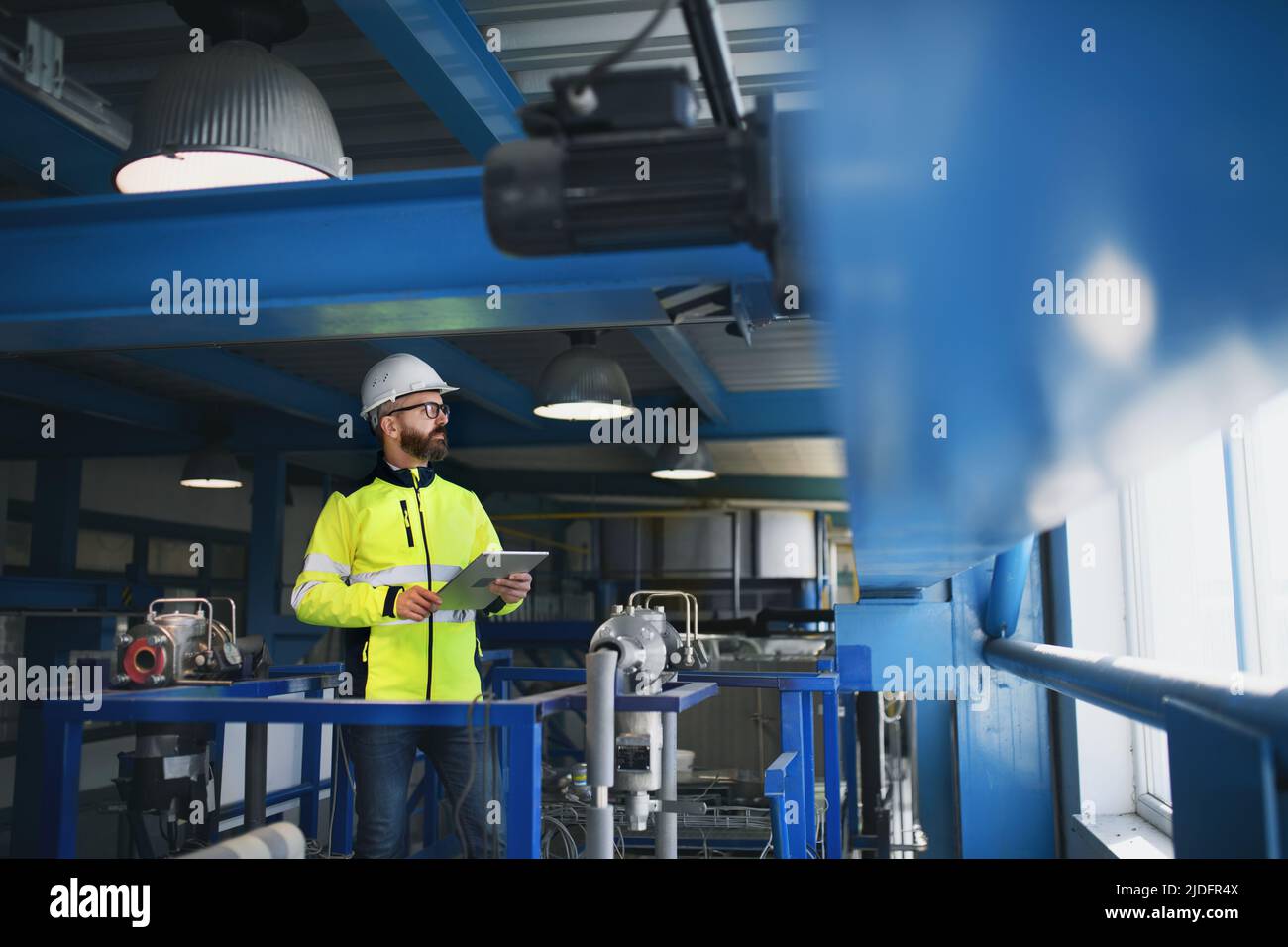 Portrait of engineer working in industrial factory Stock Photo - Alamy