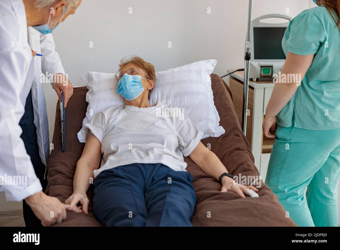 Doctors visits the patient in the ward during the procedure in hospital ...