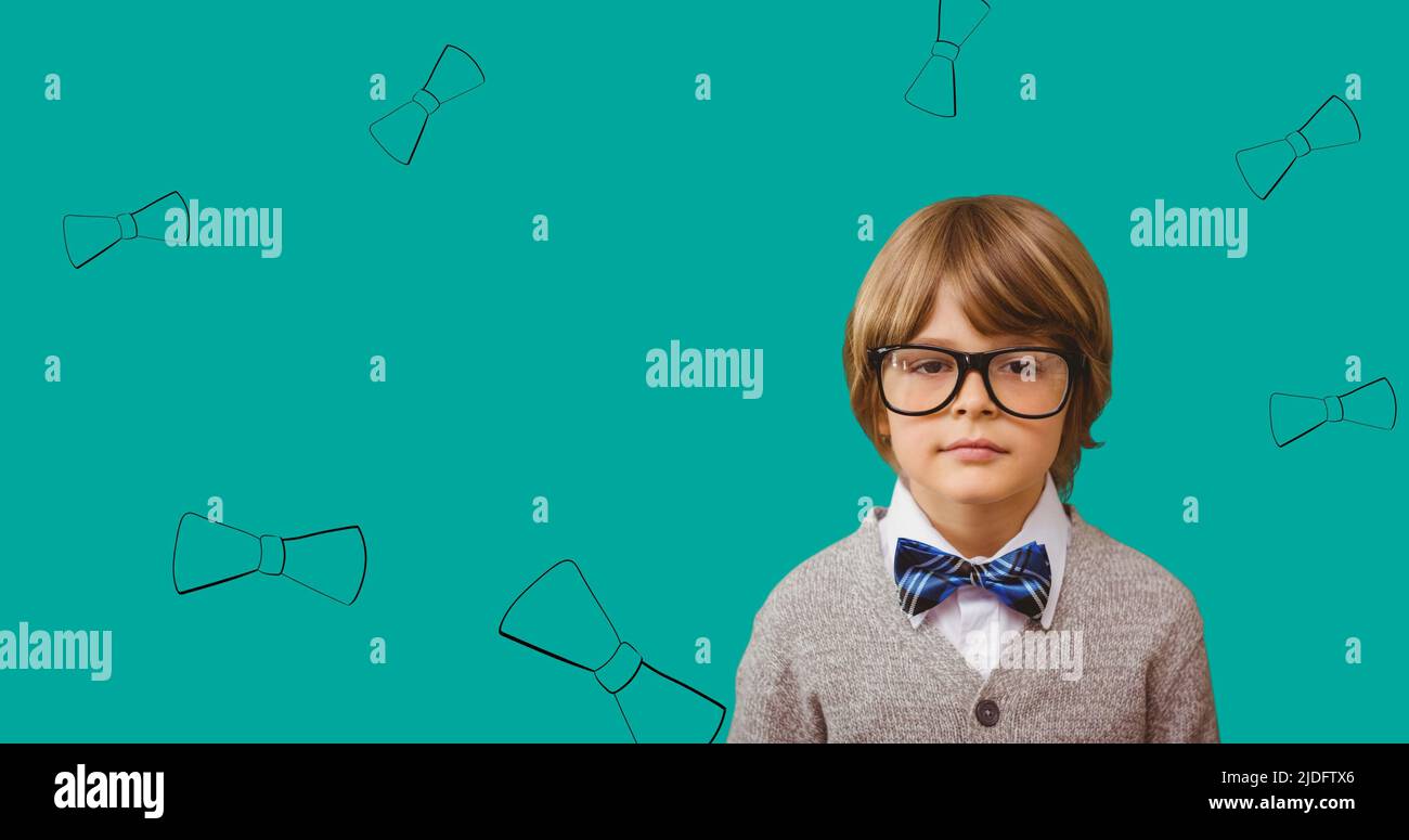 Portrait of cute caucasian boy wearing specs and bow tie on turquoise ...
