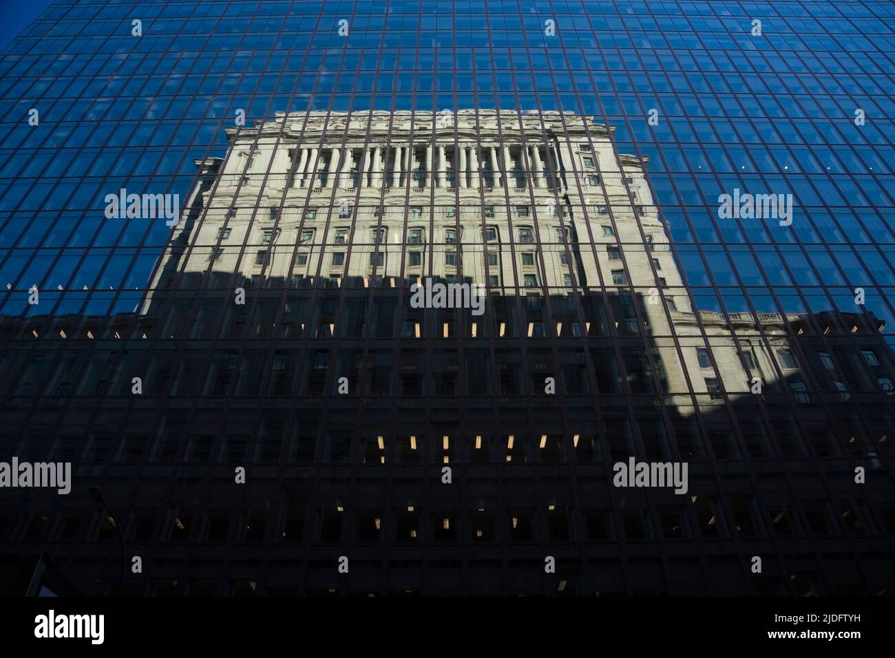 Sunlife building reflected in the windows of a glass pane building in ...
