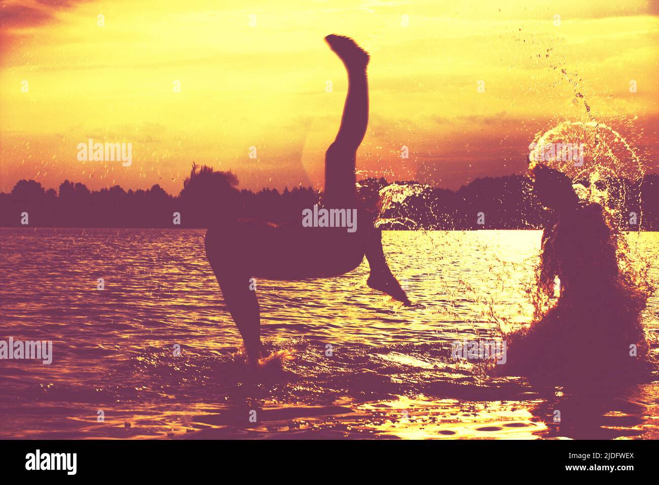Group of young people playing games on sandy beach on a summer day ...