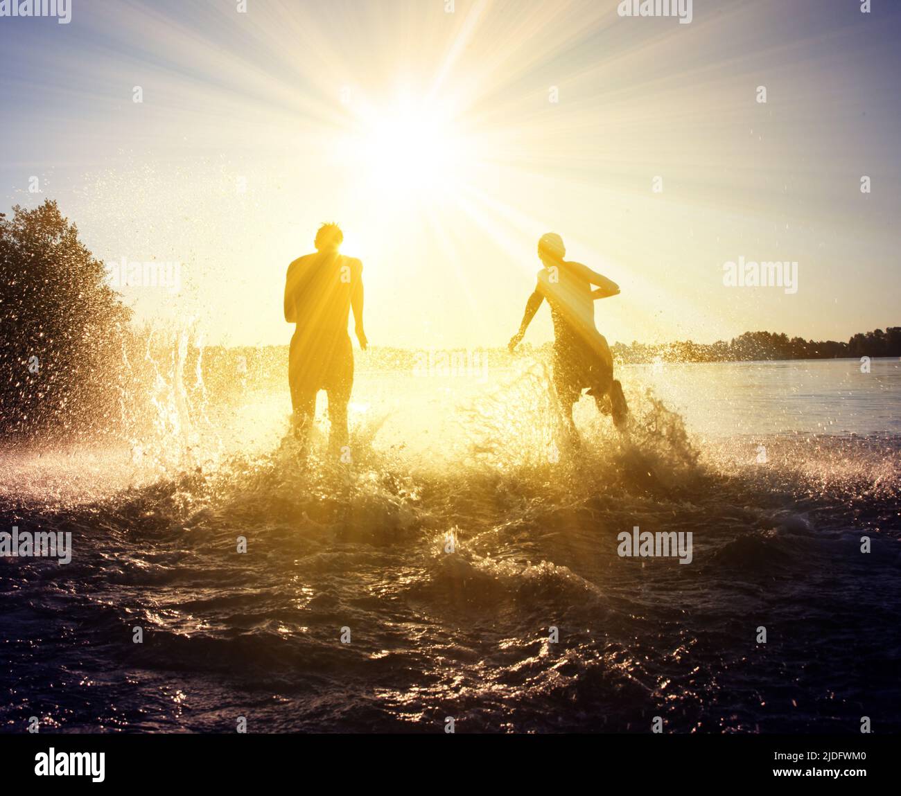 Group of young people playing games on sandy beach on a summer day ...