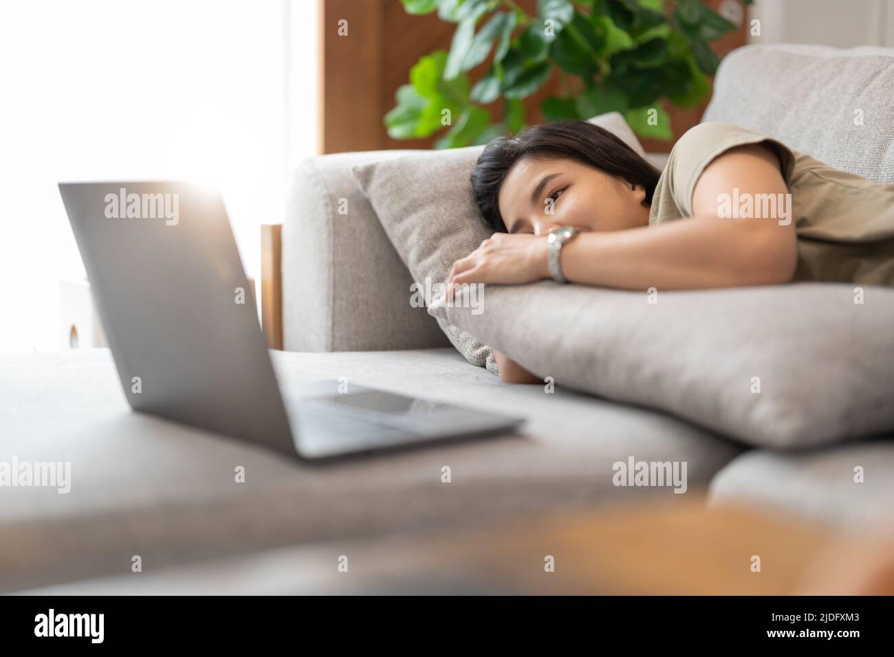 beauty asian woman watch video tv series on laptop computer happily on ...