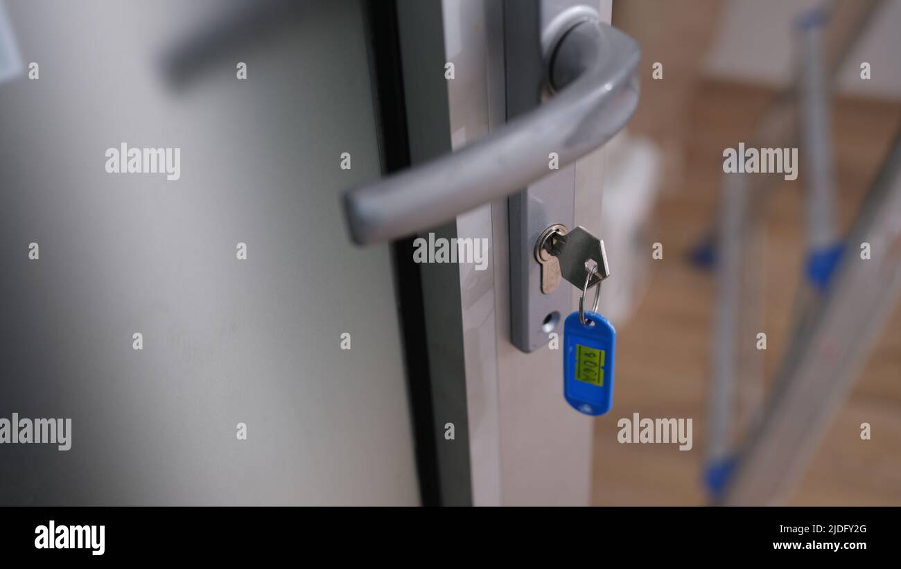 Close-up of open door with steel lock and keys with number tag ...