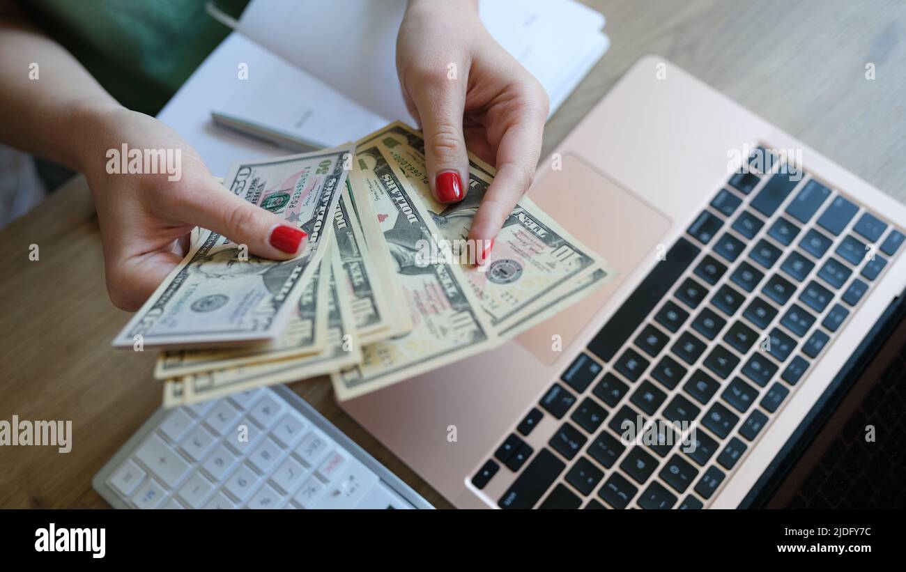 Female holding cash in hand and counting banknotes Stock Photo - Alamy