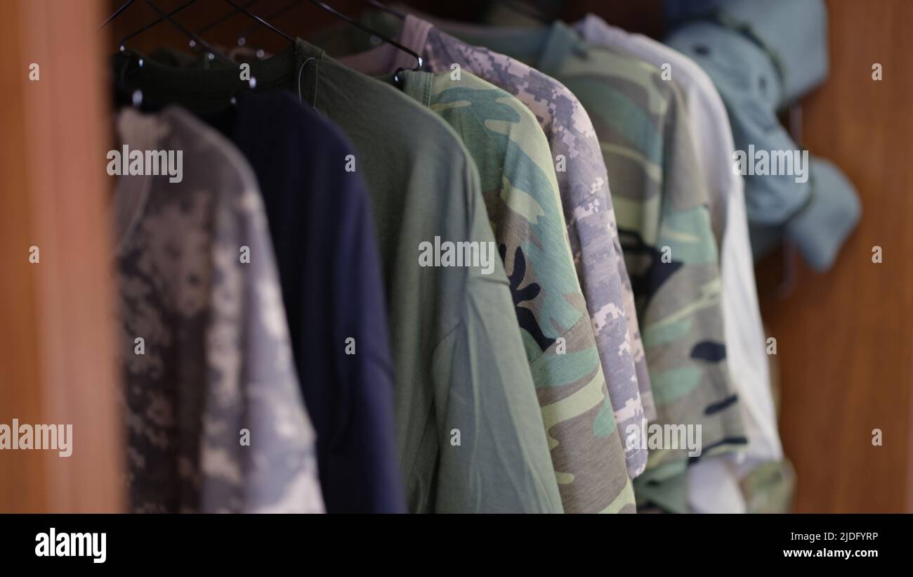 Collection of military uniform tshirts in wardrobe Stock Photo - Alamy