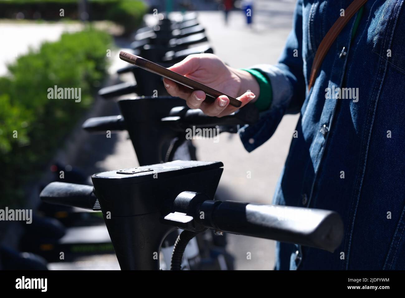 Female holding modern smartphone and paying rent Stock Photo - Alamy