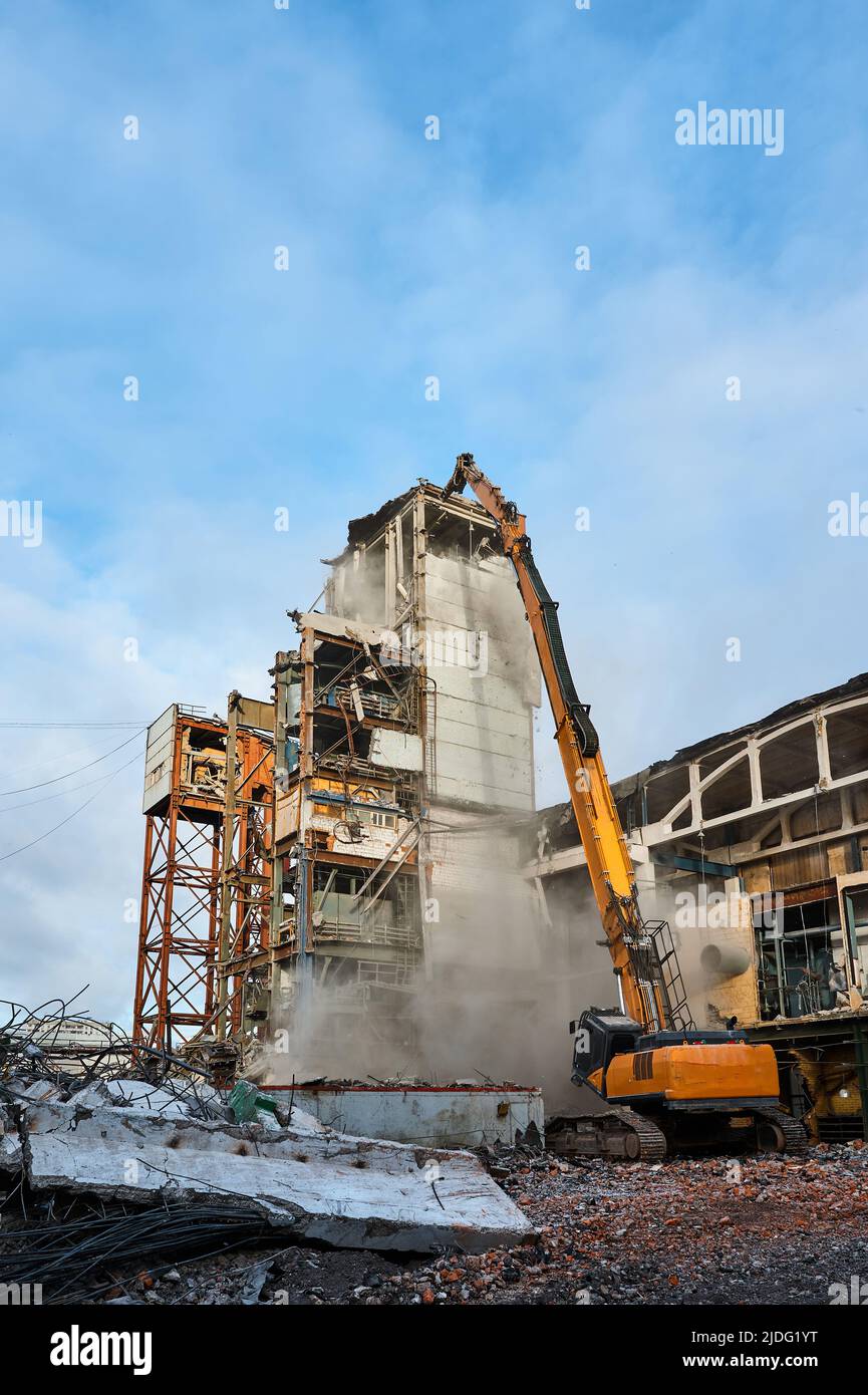 Destroying of old industrial building by excavator destroyer Stock ...