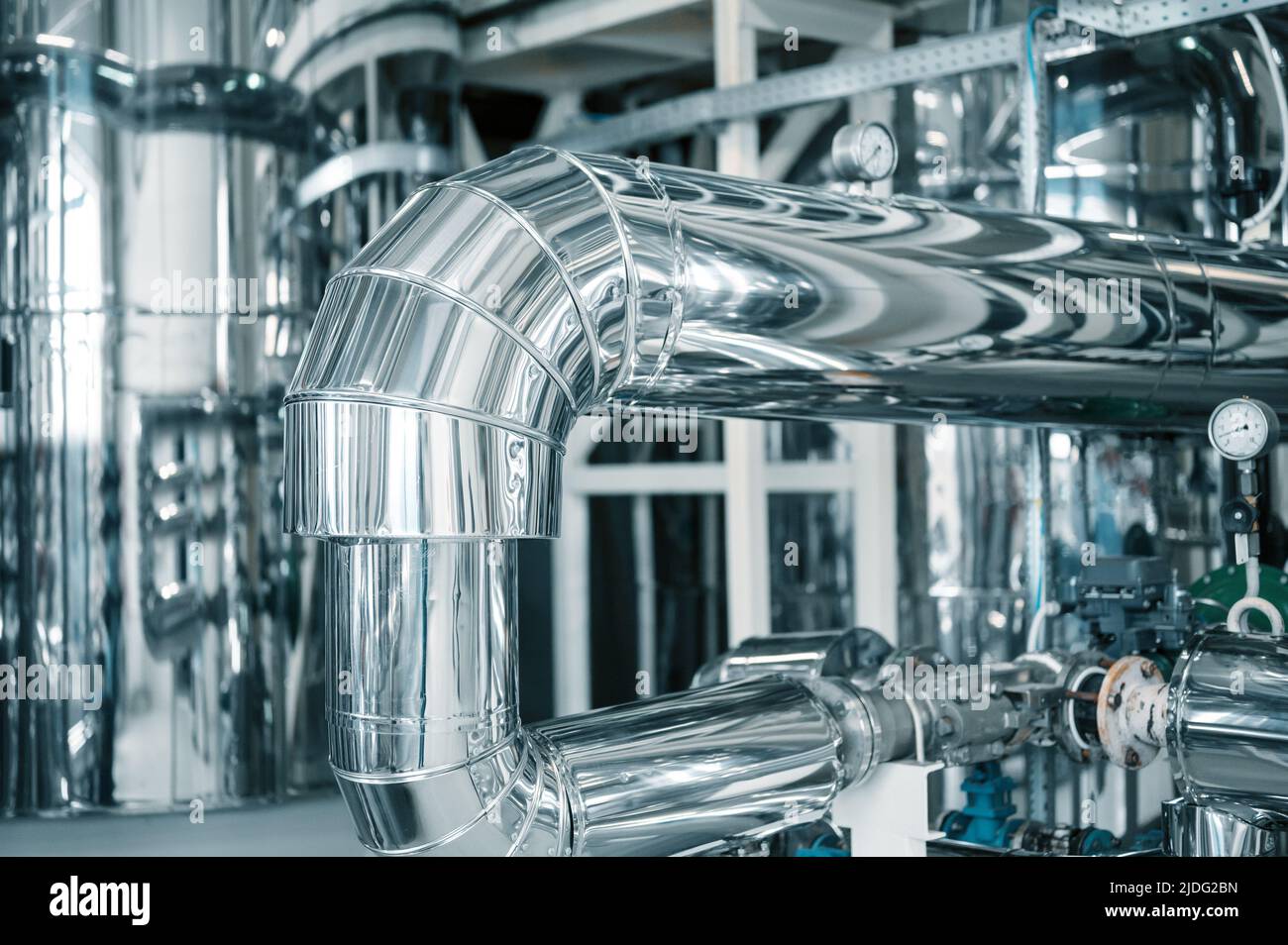 Shiny silver pipeline system and pressure meter at plant Stock Photo ...