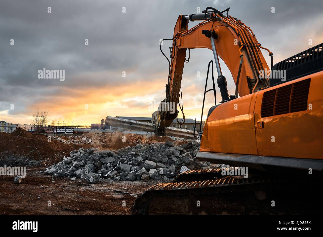 Excavator with concrete crusher on rig at demolition site Stock Photo ...