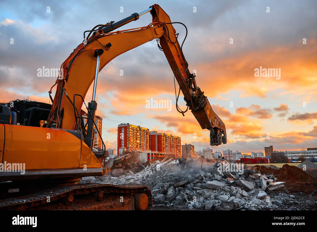 Excavator with concrete crusher on rig at demolition site Stock Photo ...