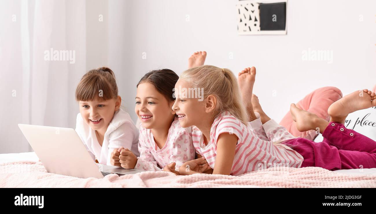 Cute little girls watching cartoons at home Stock Photo - Alamy