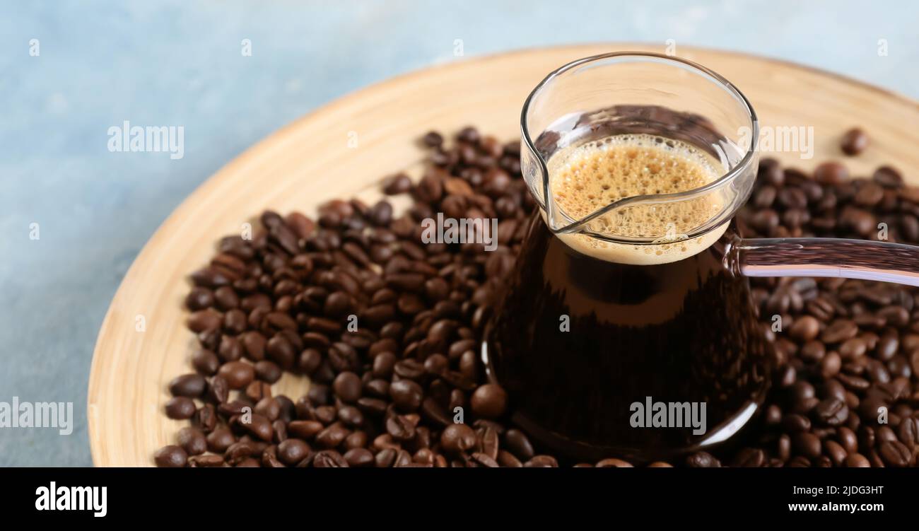 Jezve with delicious turkish coffee and plate of beans on color ...