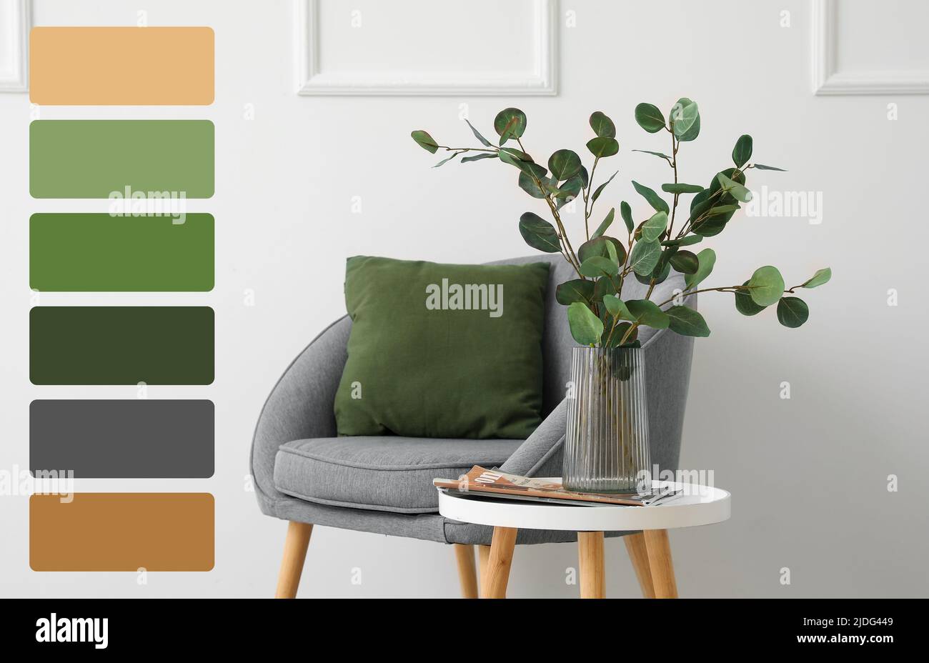 Vase with eucalyptus branches on table in room. Different color ...